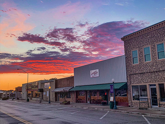 Sunset paints the sky in impossible pinks and oranges above Wilburton's storefronts, nature's way of saying "slow down and look up."