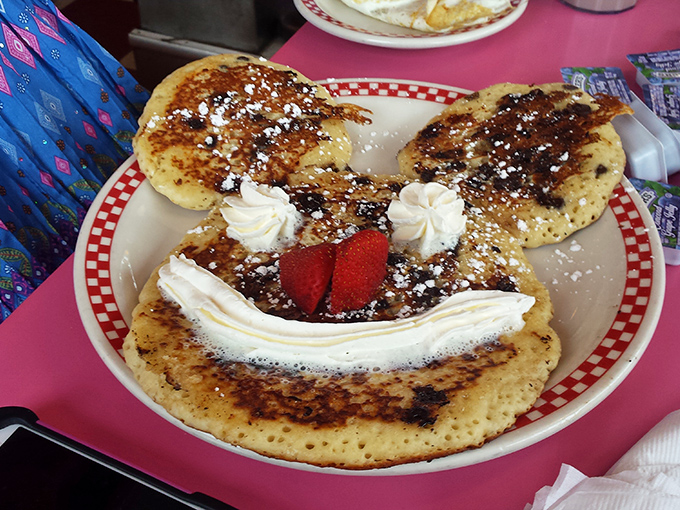 Breakfast with a smile—this pancake creation proves that morning joy can be found in whipped cream dollops, strawberries, and a touch of childlike wonder.