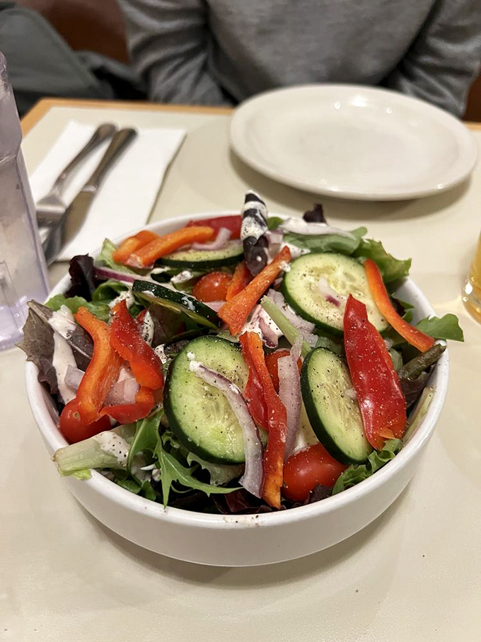 Garden-fresh ingredients that don't feel like a consolation prize. This vibrant salad holds its own even in the presence of pizza royalty.