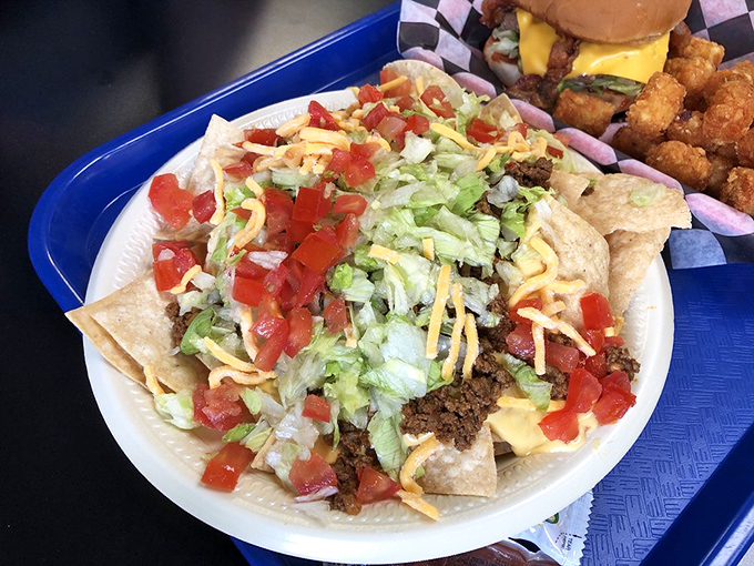 Nachos arrive as a colorful landscape of textures and flavors—a democratic party where every chip has equal access to the bounty of toppings.