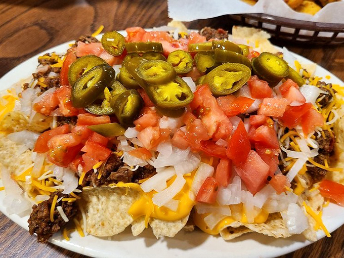 Nachos that understand the importance of proper topping distribution. Every chip deserves its moment of glory under those jalape&ntilde;os and tomatoes.
