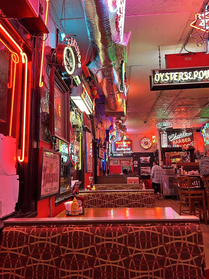 A ceiling of electric dreams and beer history. More neon signs than Times Square, with better food just beneath.