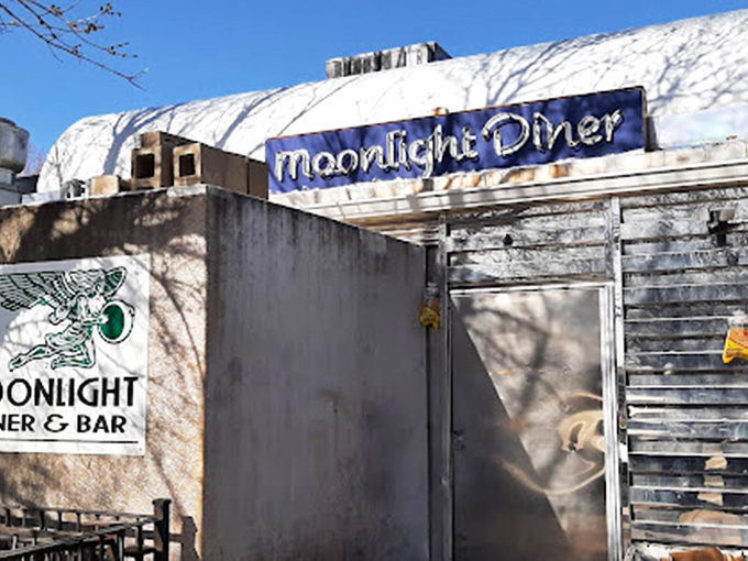 Winter transforms the Moonlight into a snow-capped sanctuary. That blue sign promises warmth, coffee, and comfort food when Colorado's weather turns fierce.