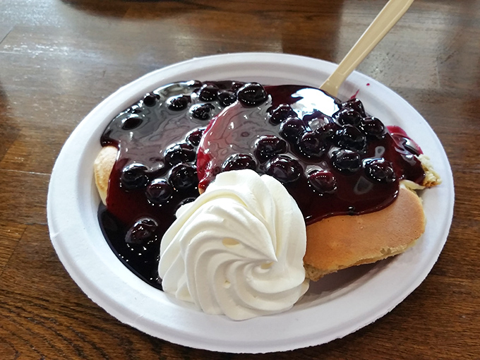 Pancakes become art when topped with blueberry compote and a perfect spiral of whipped cream. Breakfast or dessert? The line deliciously blurs.