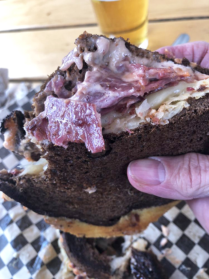 This isn't just a sandwich cross-section &ndash; it's edible architecture where each layer plays its crucial role in the pastrami masterpiece.