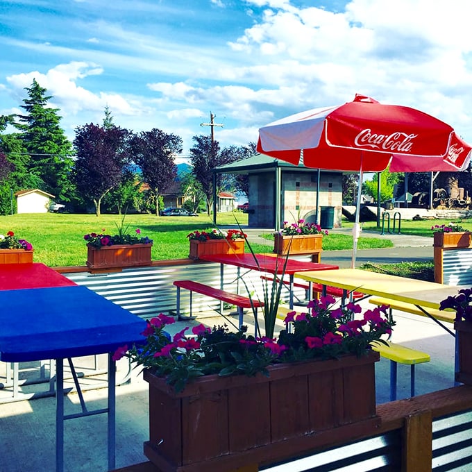 Colorful picnic tables under open skies&mdash;this patio isn't just for eating; it's for creating the summer memories that sustain us all winter.
