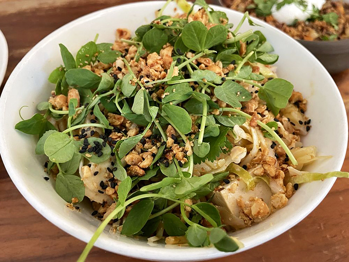 A bowl of noodles topped with fresh greens and crunchy bits. Proof that brunch doesn't always need eggs to be extraordinary.