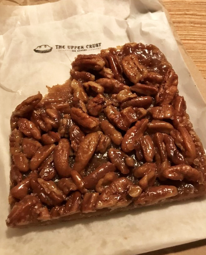 A simple white table with vibrant red chairs creates the perfect stage for pie appreciation. The fresh flowers remind you that good things come from careful nurturing.