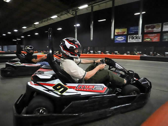 Locked in concentration, this racer demonstrates proper form while mentally calculating how to explain his victory to unimpressed friends later.