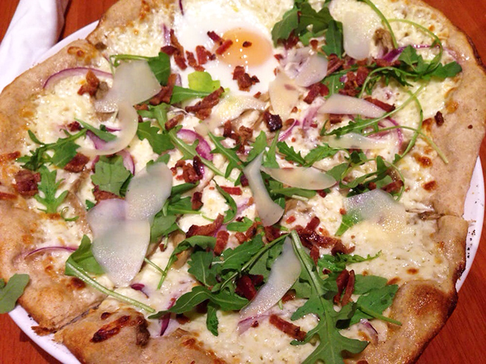This isn't just pizza&mdash;it's a flatbread canvas showcasing local ingredients. The arugula adds a peppery bite that cuts through the richness perfectly.