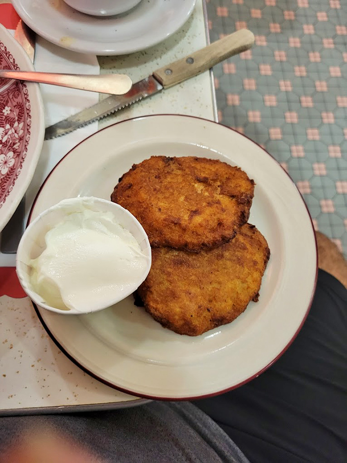 Potato pancakes with a golden crust that makes the perfect crunch sound&mdash;the one that says "this is worth every calorie." The sour cream is non-negotiable.