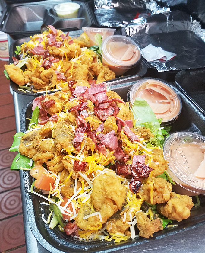 Fried seafood gets dressed up with cheese, bacon and greens. It's like a salad having an identity crisis in the most delicious way possible.