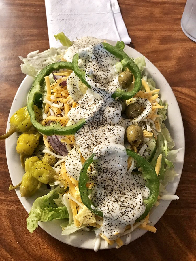 A salad that doesn't apologize for being indulgent. Those green peppers and olives are technically vegetables, so this counts as healthy, right?