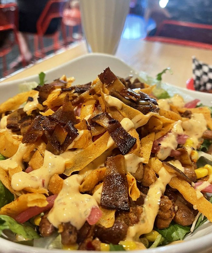 A salad that doesn't apologize for being delicious&mdash;crisp greens playing host to a party of toppings and sauce.