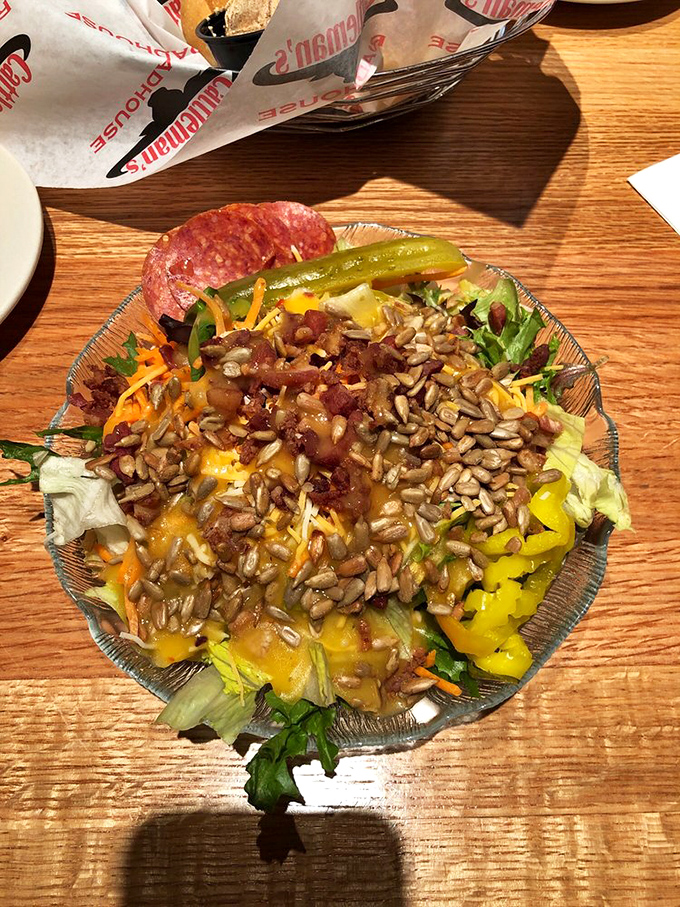 A salad that's trying its best to be healthy but can't help showing off with bacon, cheese, and sunflower seeds&mdash;bless its heart.