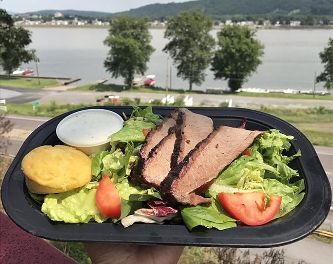 Sliced brisket atop fresh greens proves barbecue can be elegant too. That smoke ring is the pink badge of honor in BBQ circles.