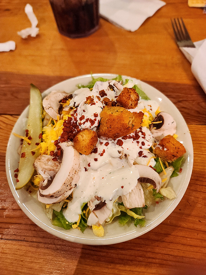 A salad that doesn't apologize for being hearty&mdash;loaded with cheese, croutons, and what appears to be bacon bits, because even vegetables deserve their moment.