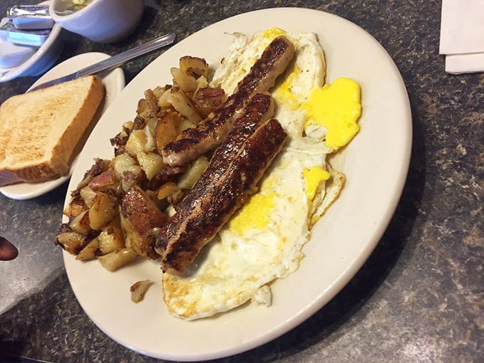 The breakfast trinity: perfectly cooked eggs, crispy home fries, and sausage links with just the right snap when you bite into them.
