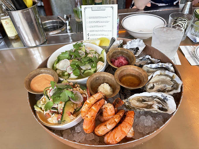 The seafood platter arrives like a United Nations of ocean delicacies, each with its own diplomatic immunity from criticism.