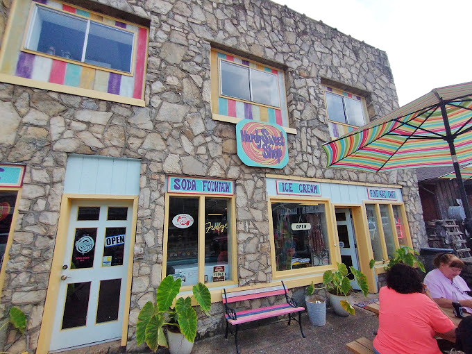 The shop's exterior signage promises three essential food groups: soda fountain, ice cream, and fudge – the cornerstones of any balanced diet.