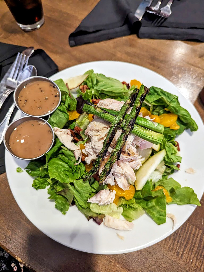 A salad that doesn't apologize for being healthy. Grilled asparagus and tender chicken prove barbecue joints can do green things too.