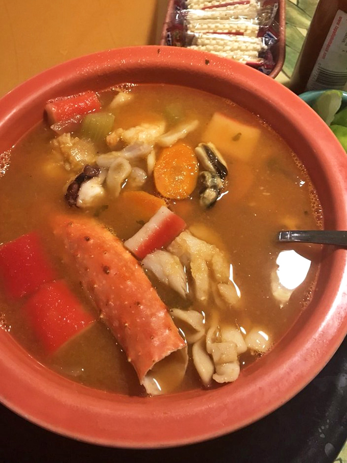 A seafood soup so hearty it could qualify as a maritime rescue operation. That crab leg is just showing off.