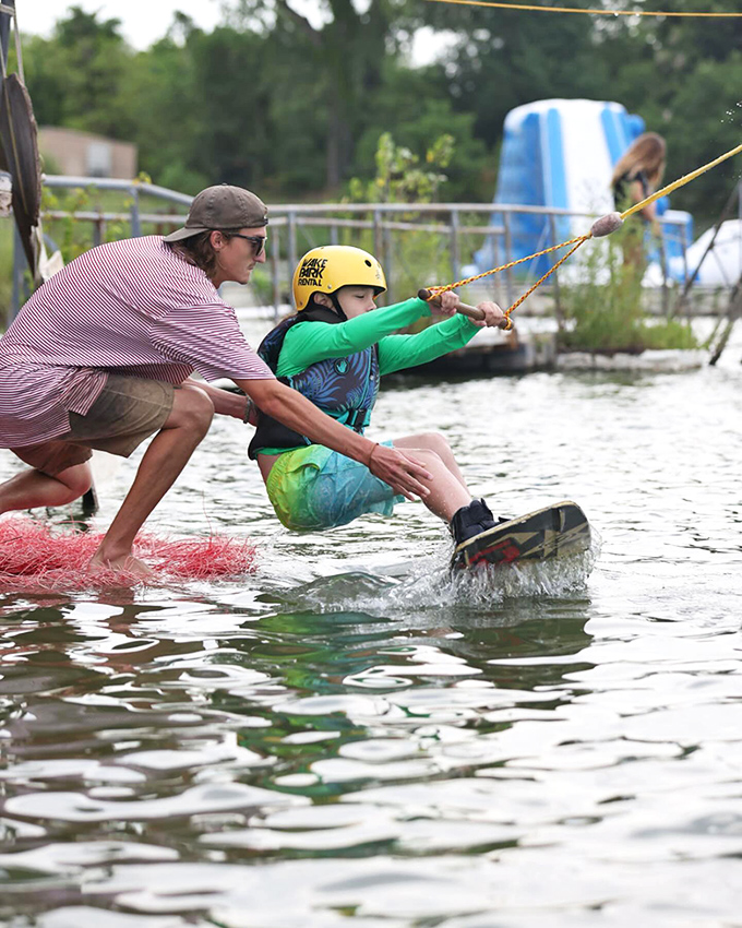 The gentle art of wakeboarding instruction. That moment when adult guidance meets childhood determination, creating the perfect learning environment.