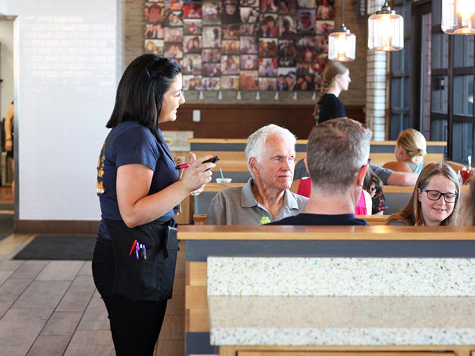 Great service isn't just bringing food&mdash;it's creating moments. This server isn't taking an order; she's starting the first chapter of someone's perfect meal.