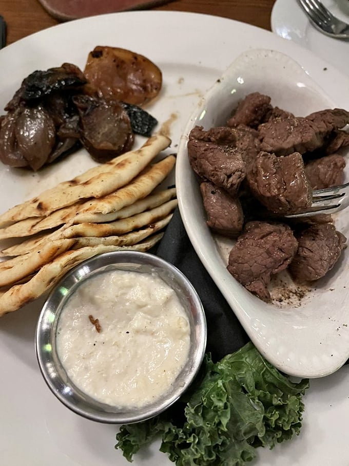 Steak tips that make small bites feel like big decisions, paired with the kind of horseradish sauce that clears sinuses three tables away.