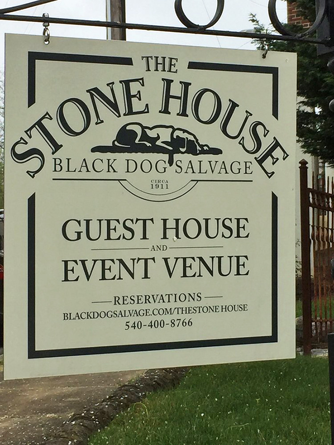 The Stone House sign promises more than just overnight accommodations. It's an invitation to literally sleep surrounded by the Black Dog aesthetic.
