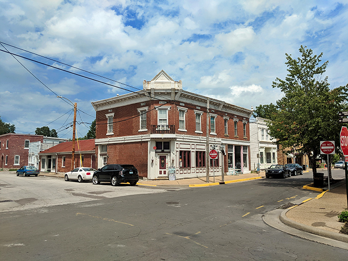 Corner buildings with history etched into every brick, where modern cars park alongside structures that have witnessed centuries of American life unfold.