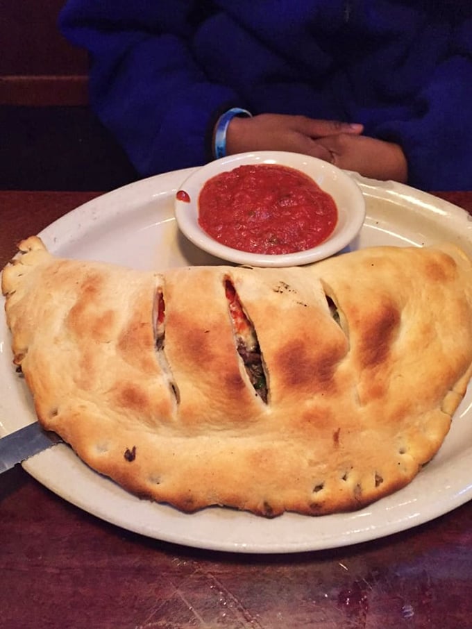 This stromboli isn't just a meal—it's an architectural achievement. Perfectly golden crust housing a treasure of fillings worth every delicious calorie.