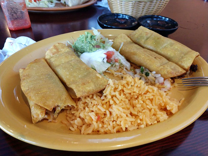 Golden-fried taquitos lined up like delicious soldiers, ready to battle hunger with their crispy exteriors and flavorful fillings.
