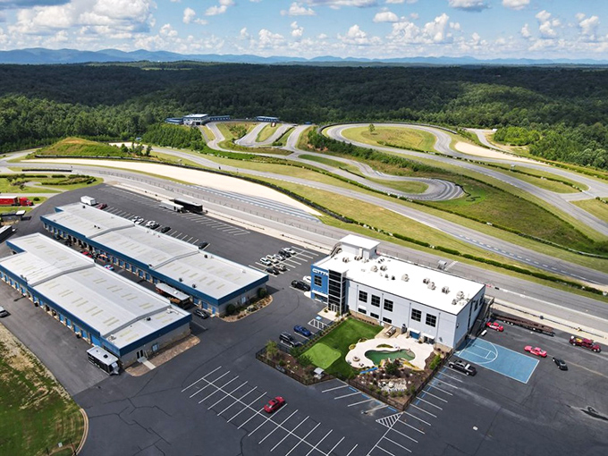 The bird's-eye view reveals Atlanta Motorsports Park's magnificent layout – a ribbon of asphalt paradise carved into Georgia's lush landscape.