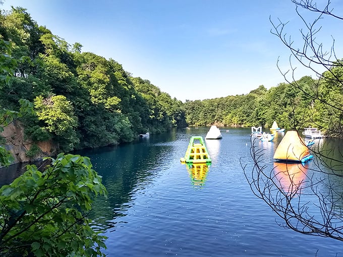 Nature's perfect swimming pool. The quarry's emerald waters, framed by lush Pennsylvania forest and dotted with colorful inflatables, create a scene straight from summer dreams.