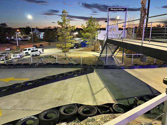 Twilight transforms the track into a neon-kissed playground where day's final races unfold beneath a sky as dramatic as the competition below.