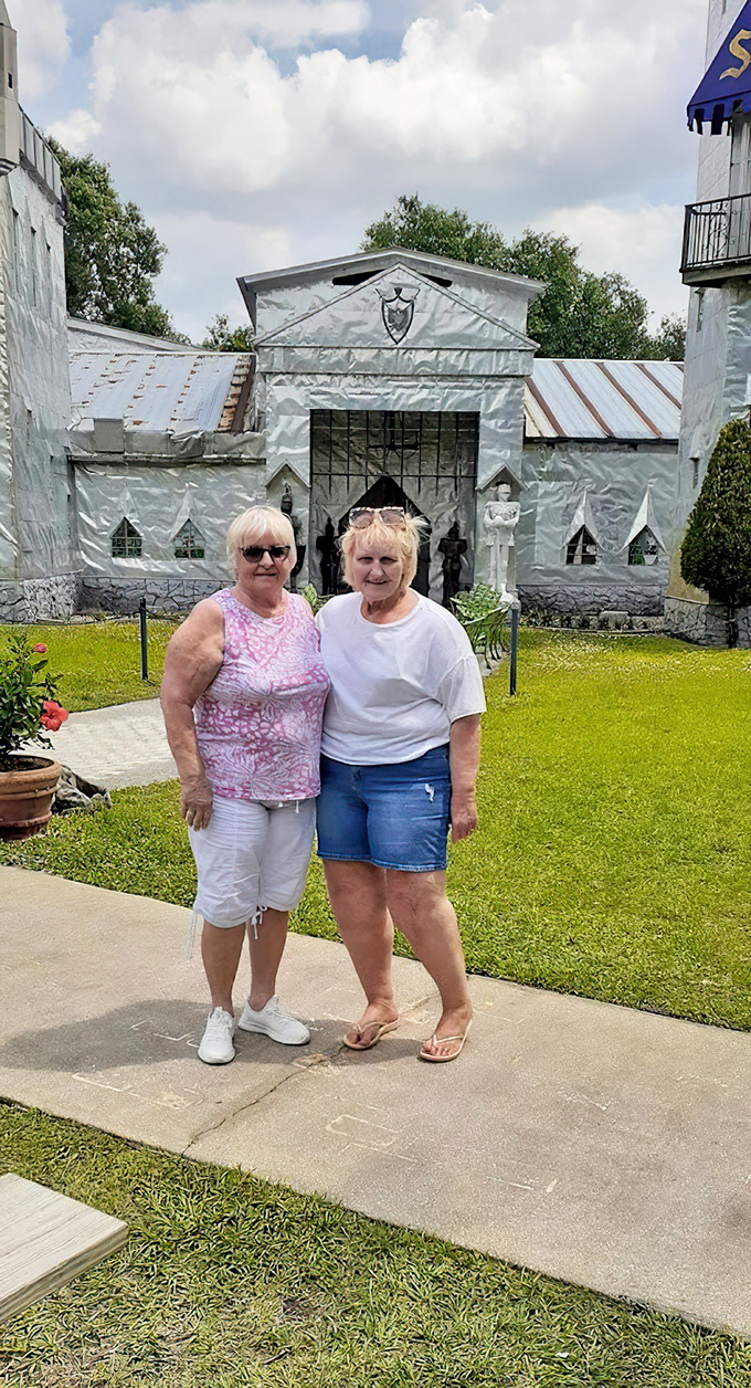 Visitors pose proudly before the silver castle walls. The Florida sun might be hot, but discovering this hidden gem makes it worth every degree.