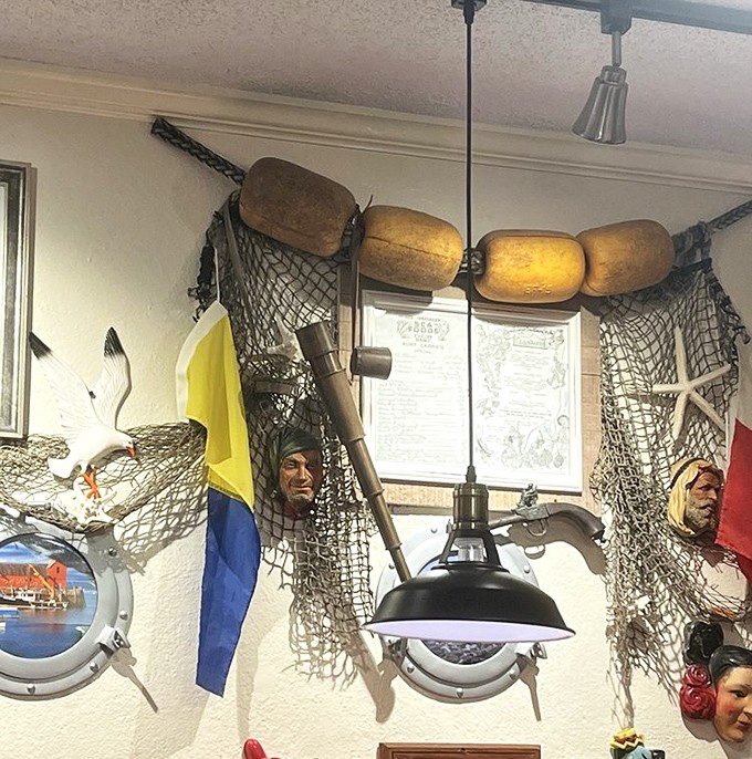 The wall decor features fishing nets, buoys, and enough maritime paraphernalia to outfit a small fleet. Somewhere, Neptune is missing his living room furniture.