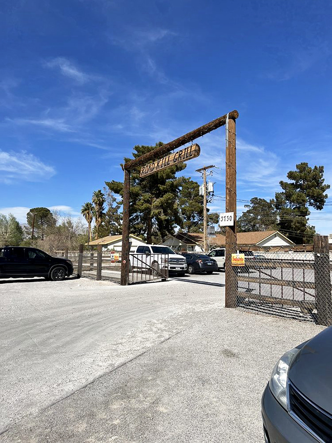 The rustic entrance sign stands as a humble gatekeeper to a world where smoke, meat, and time create edible magic.