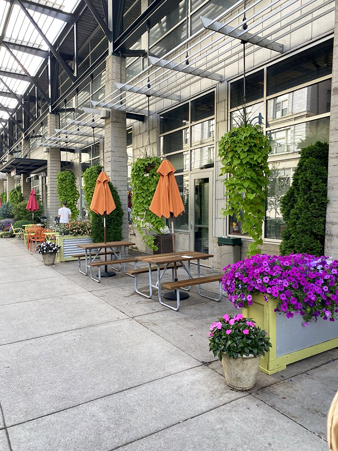 Outdoor seating that beckons on sunny Milwaukee days, where purple petunias frame conversations about which seafood to try next.