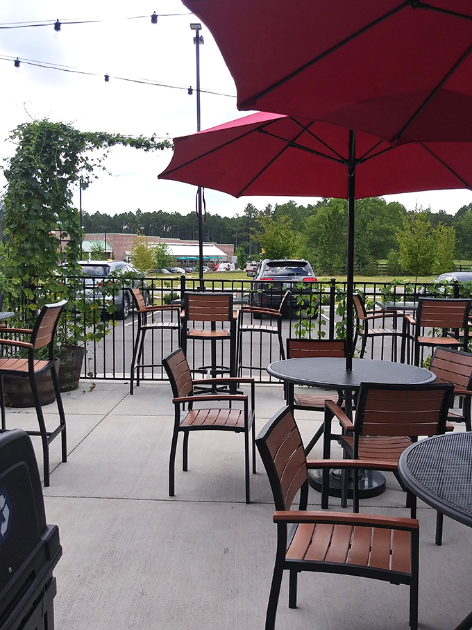 Garden-side dining under crimson umbrellas &ndash; because sometimes the only thing better than a perfect sandwich is enjoying it in the Carolina sunshine.