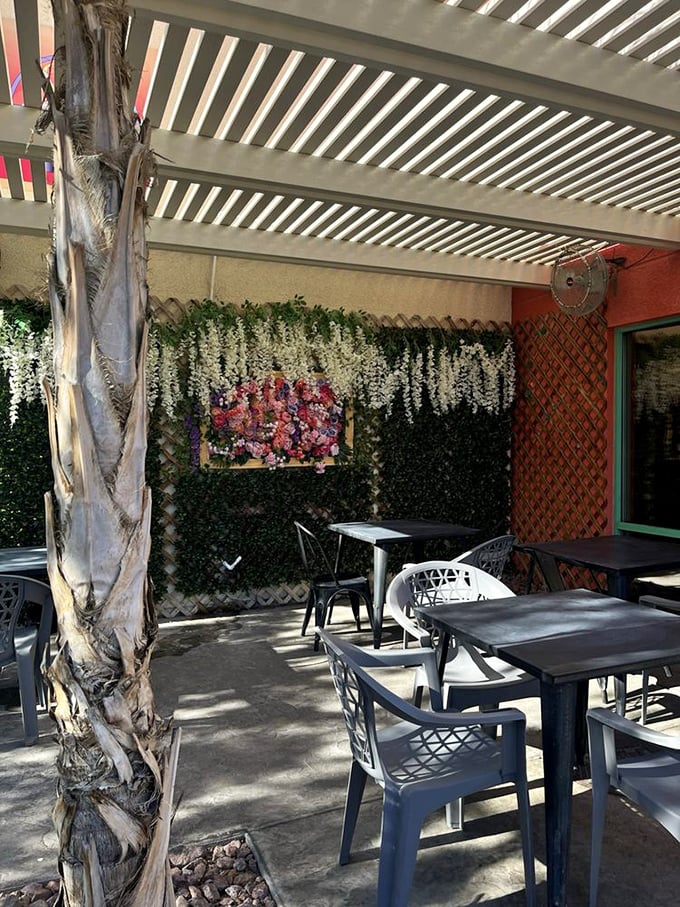 The outdoor seating area offers a tranquil escape, where artificial flowers never wilt and your only worry is choosing what to order next.