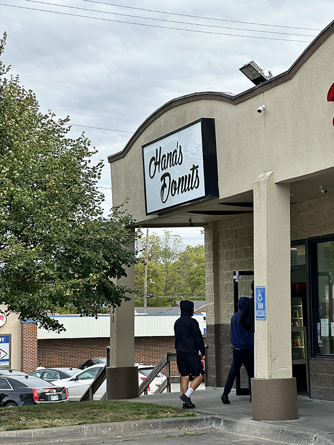 The pilgrimage begins here. Two customers about to experience what locals already know &ndash; this doorway leads to donut paradise.