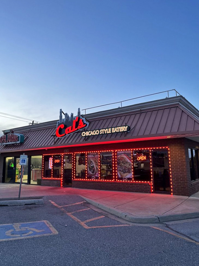 As evening falls, Cal's neon glow becomes a beacon for sandwich seekers &ndash; a red-lit promise of Chicago comfort in Oklahoma terrain.