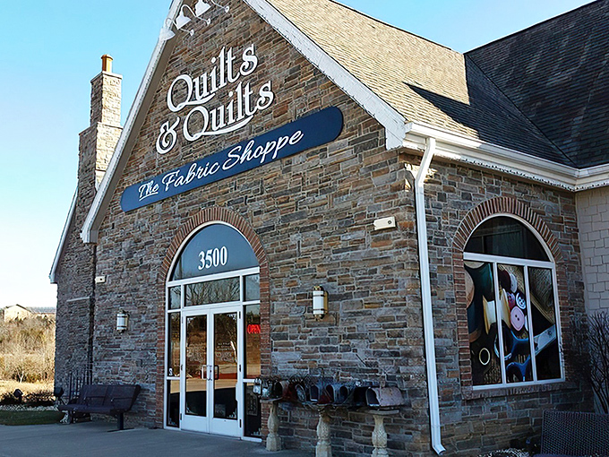 Morning light illuminates the stone exterior, giving no hint of the fabric frenzy that awaits inside this unassuming crafting paradise.