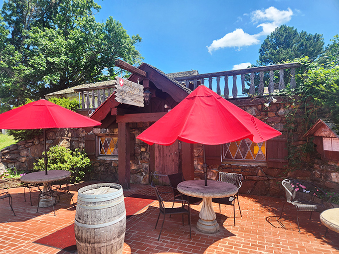 The outdoor patio where European charm meets Arkansas sunshine. Those red umbrellas aren't just shade&mdash;they're exclamation points on a perfect afternoon.