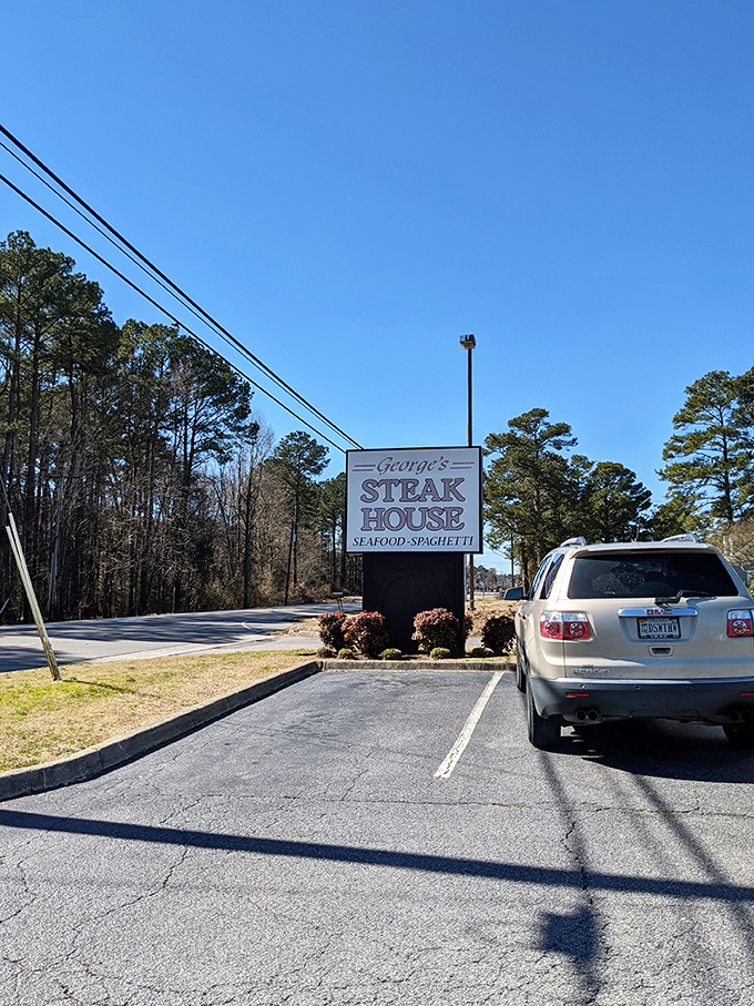 The roadside sign stands like a beacon of hope for hungry travelers. That SUV driver clearly knows the secret to happiness lies just beyond those doors.