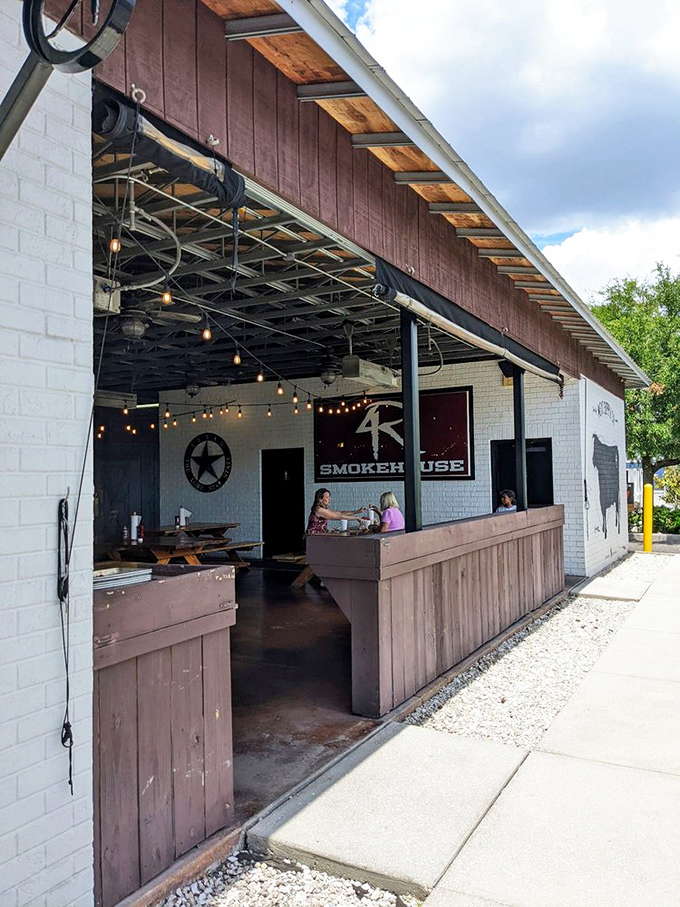 The outdoor service area, where string lights and white brick create the perfect backdrop for summer evenings and smoky delights.