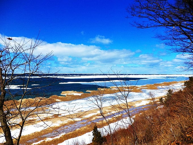 Winter waves crash against Lake Michigan's ice-lined shores, proving Saugatuck's dramatic beauty doesn't hibernate when temperatures drop—it just changes outfits.