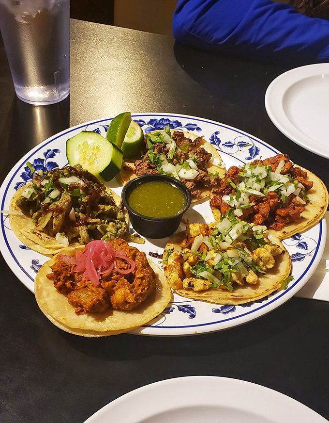 A taco platter that showcases the art of simplicity &ndash; fresh ingredients, proper proportions, and a center stage for that legendary green sauce.